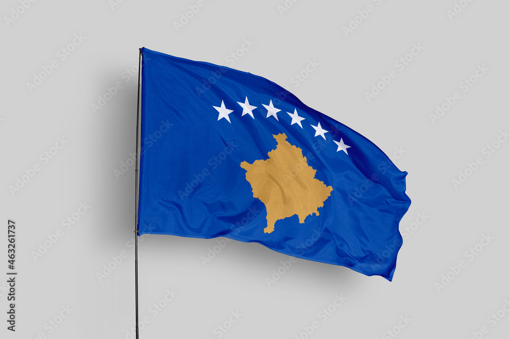 Kosovo flag isolated on the blue sky background. close up waving flag ...