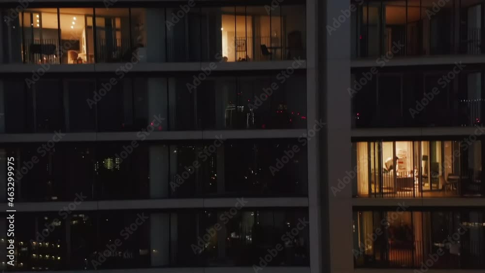 Crane up footage of high rise residential building at night. Close up ...