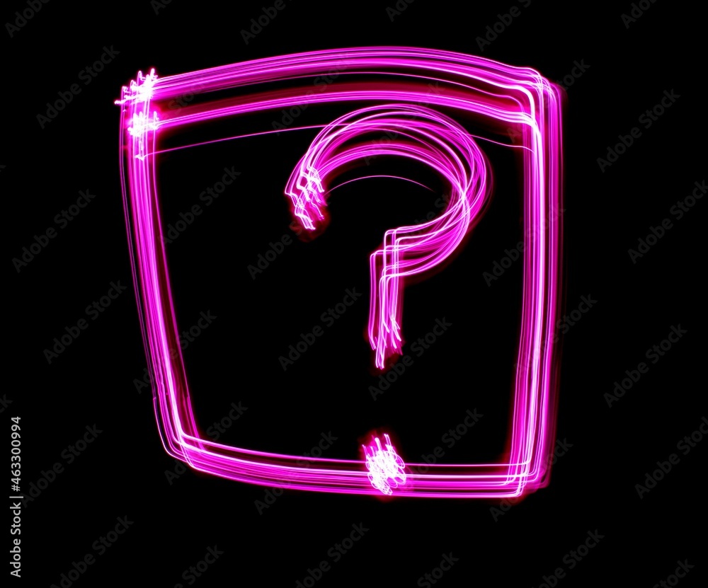 Long exposure photograph of neon pink colour in a question mark shape ...