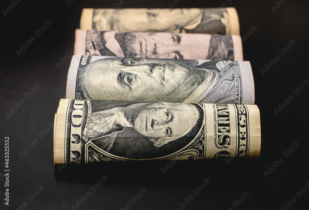 Us Dollar banknotes rolled up in photo closeup with black background ...