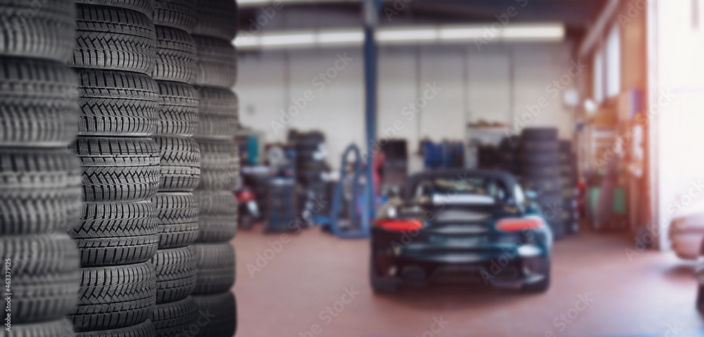 tire at repairing service garage background. Technician man replacing ...