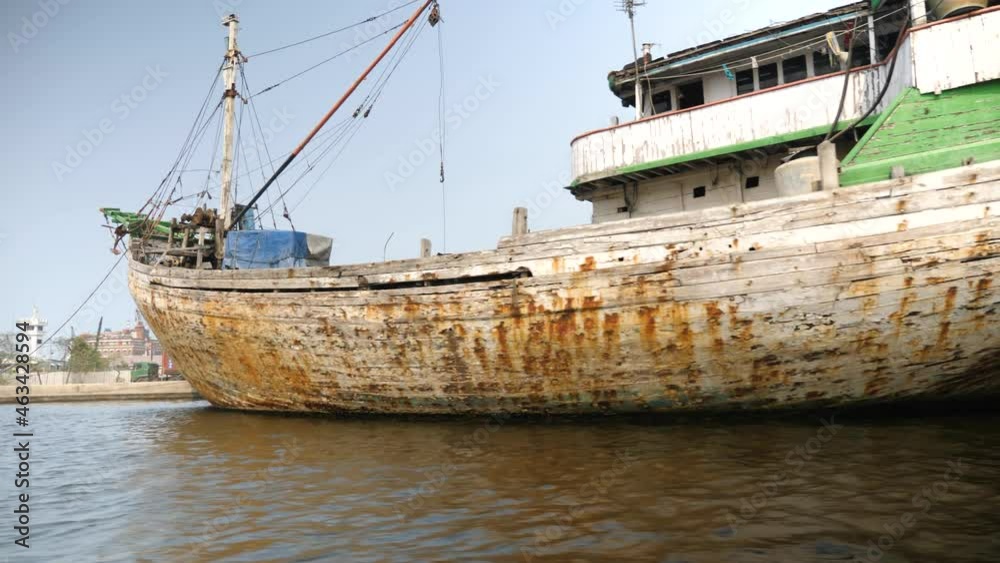 Close up 4K view of a Pinisi wooden boat from a canal. Indonesian ...