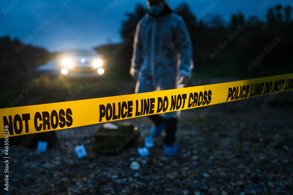 Forensic police investigator collecting evidence at the crime scene by ...