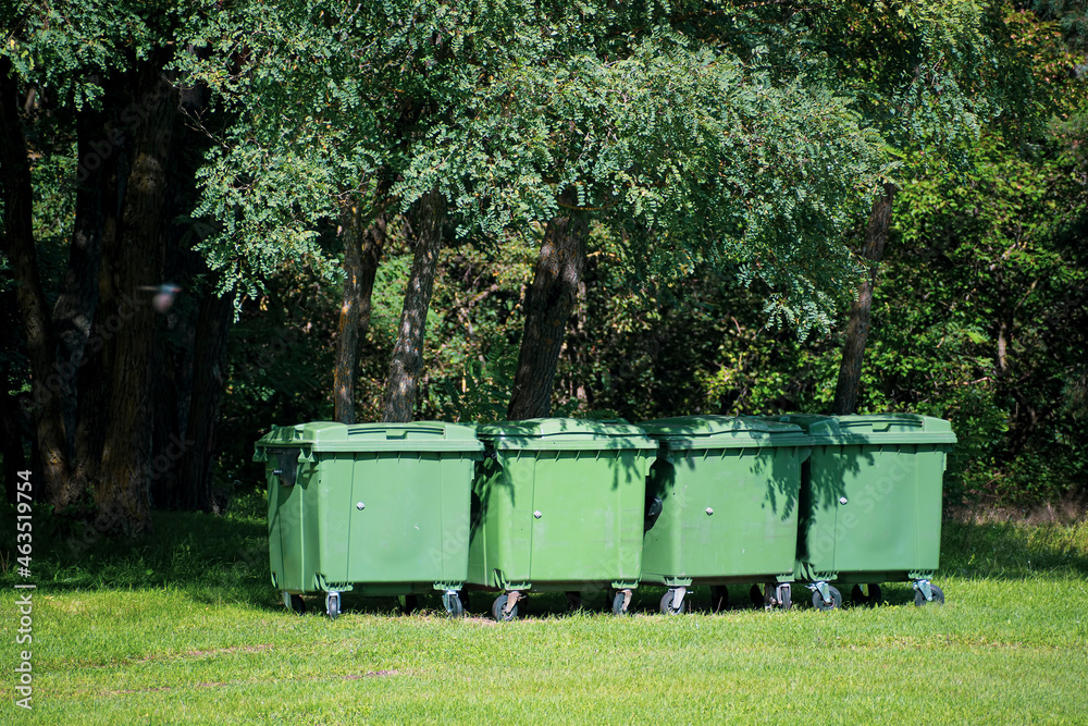 Large plastic trash bins for garbage in an outdoor park. Environmental ...