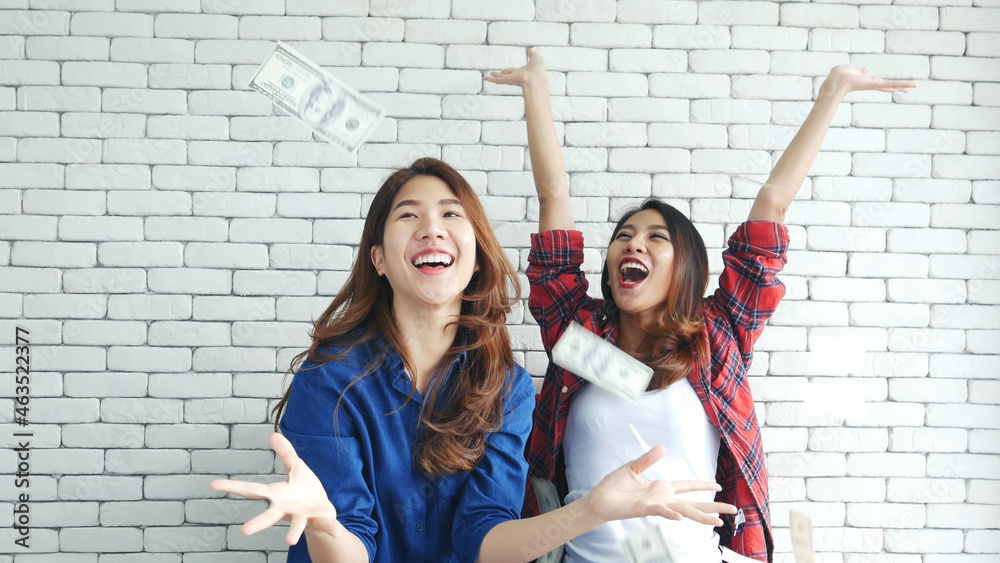 Happy young asian woman holding dollar money and throw in the air ...