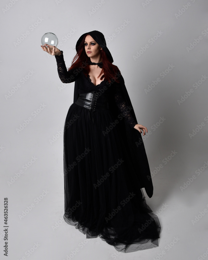 Full length portrait of dark haired woman wearing black victorian witch ...