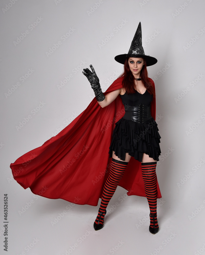 Full length portrait of dark haired woman wearing black victorian witch ...
