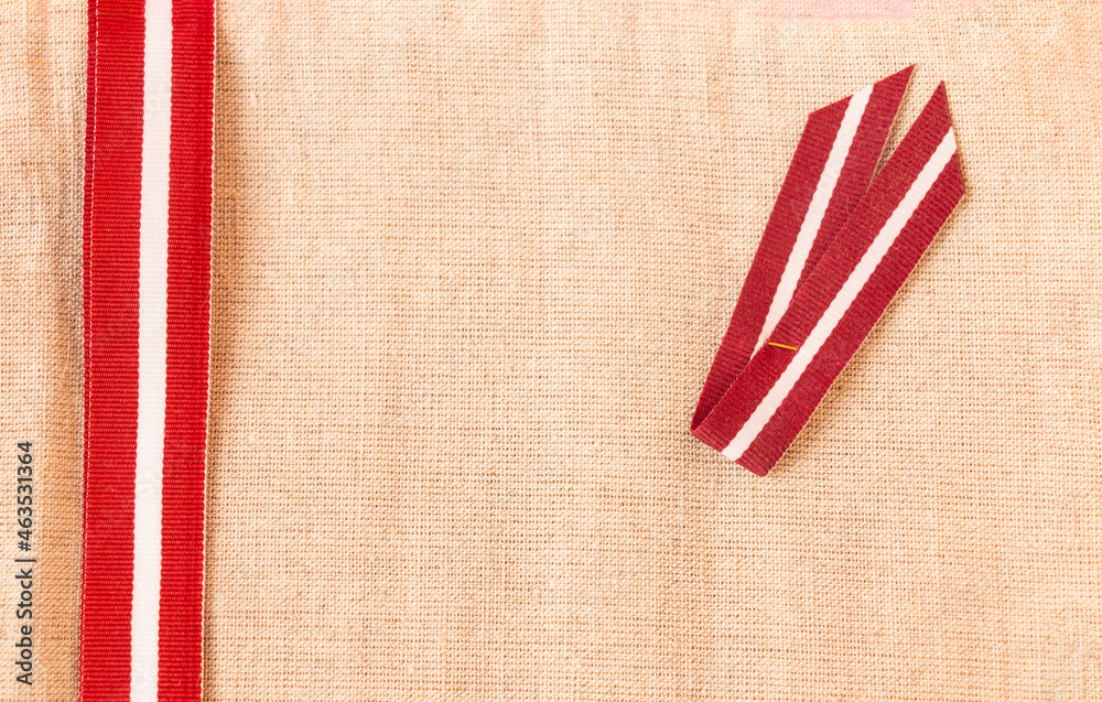 red and white ribbon on linen fabric, symbol of the day of the ...