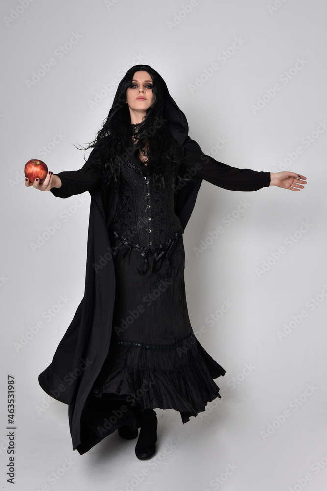 Full length portrait of dark haired woman wearing black victorian witch ...