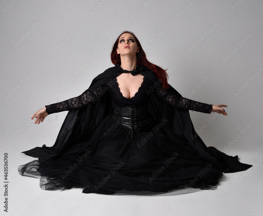 Full length portrait of dark haired woman wearing black victorian witch ...