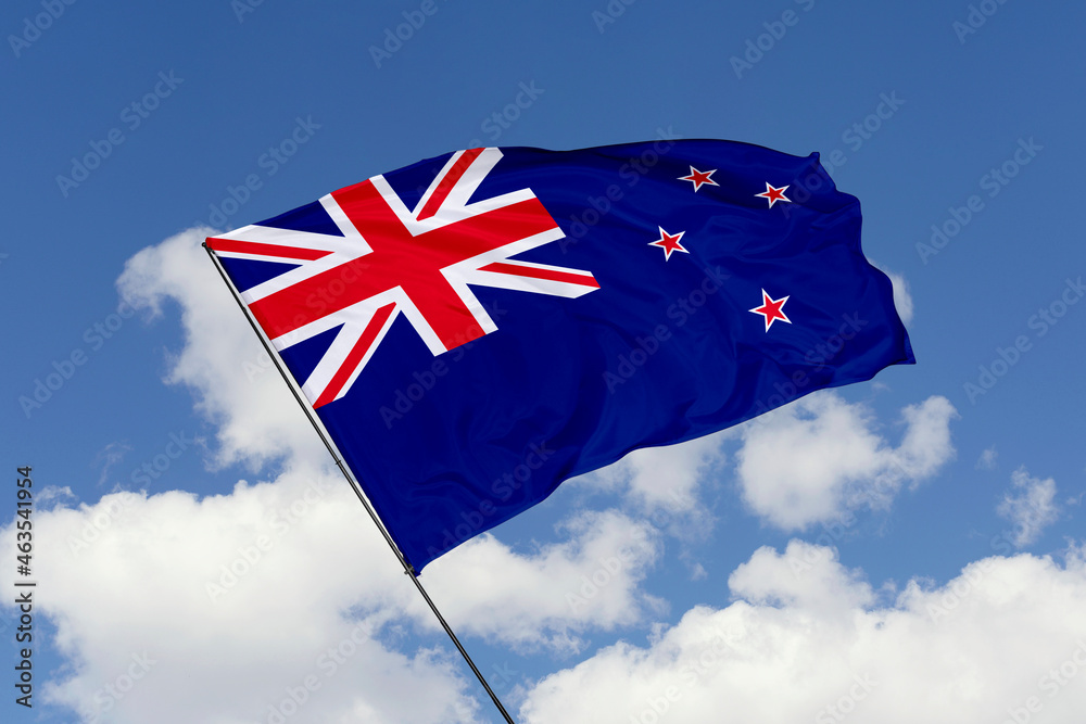 New Zealand flag isolated on the blue sky background. close up waving ...
