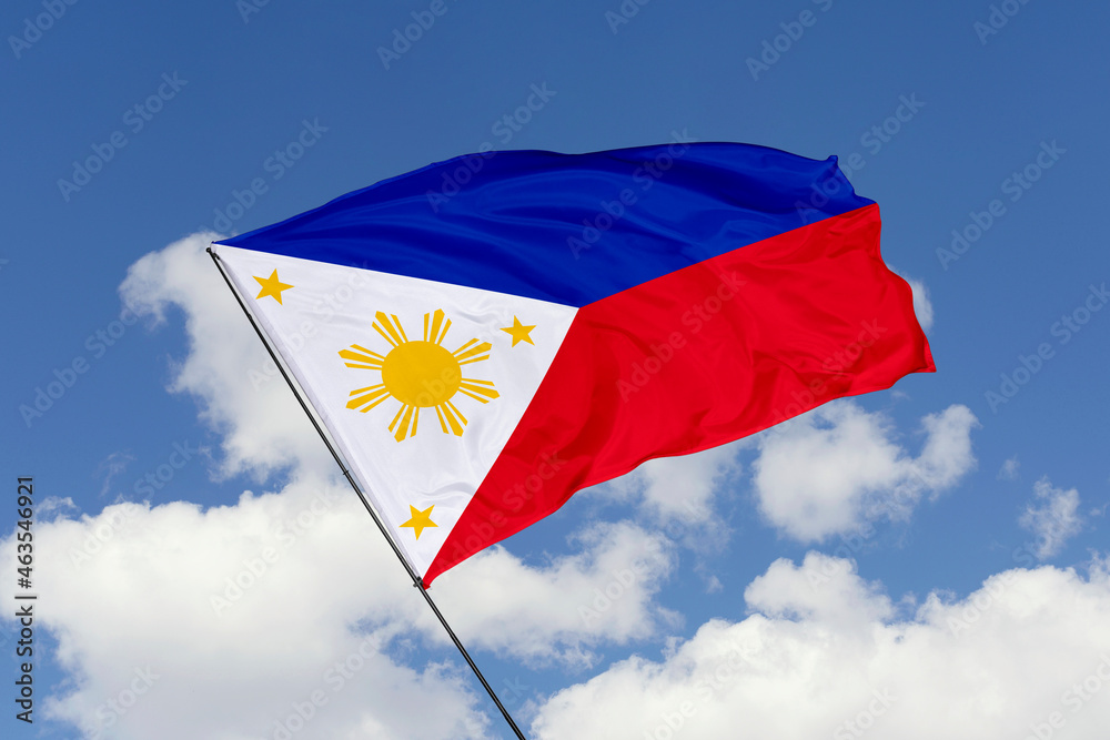 Philippines flag isolated on the blue sky background. close up waving ...