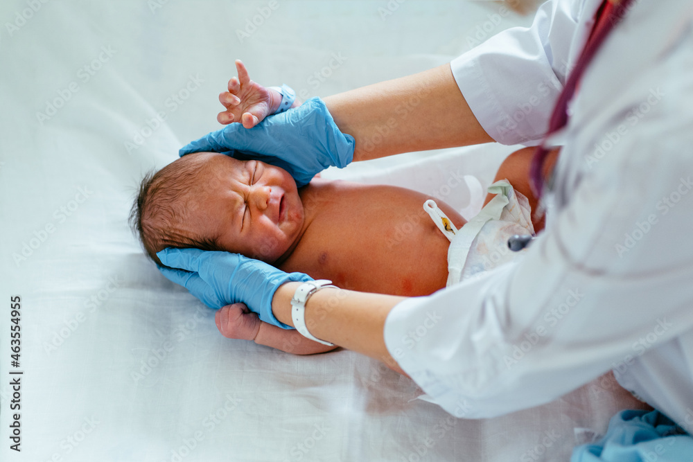 Unrecognizable doctor paediatrician examining crying infantbaby in ...