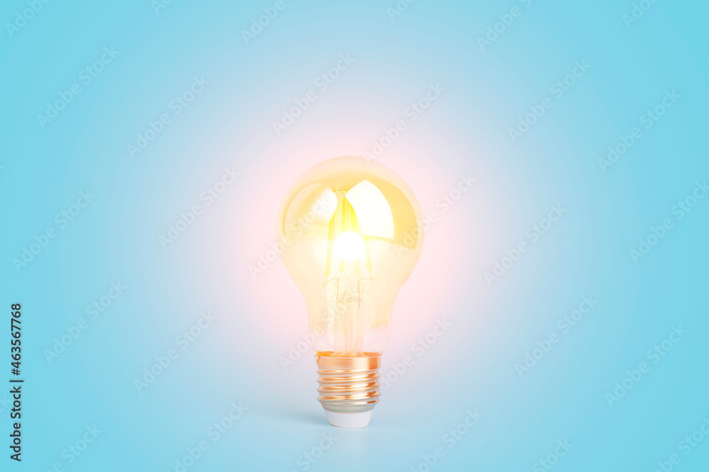 Knowledge and idea concept. Light bulb with light on a blank blue ...