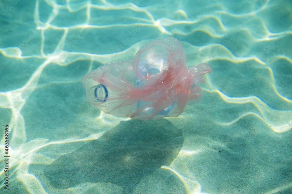 Ocean pollution. Personal protective mask, plastic bottle and bag ...