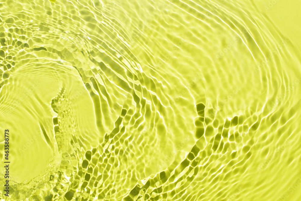 Water spills on a light green yellow background. Beautiful bursts and ...