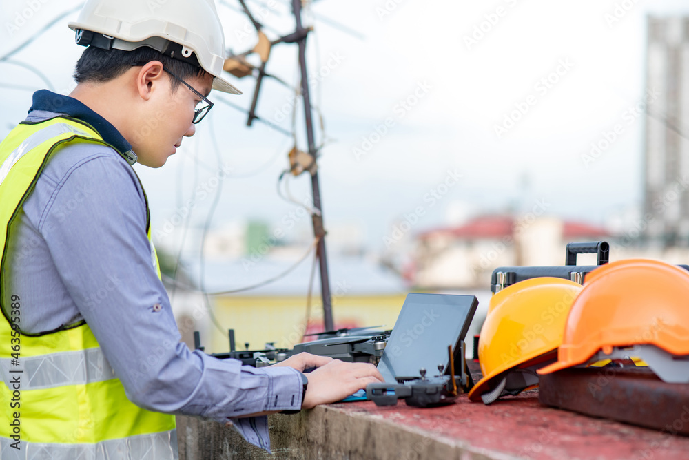 Fotografia do Stock: Asian engineer man working with drone, laptop and ...