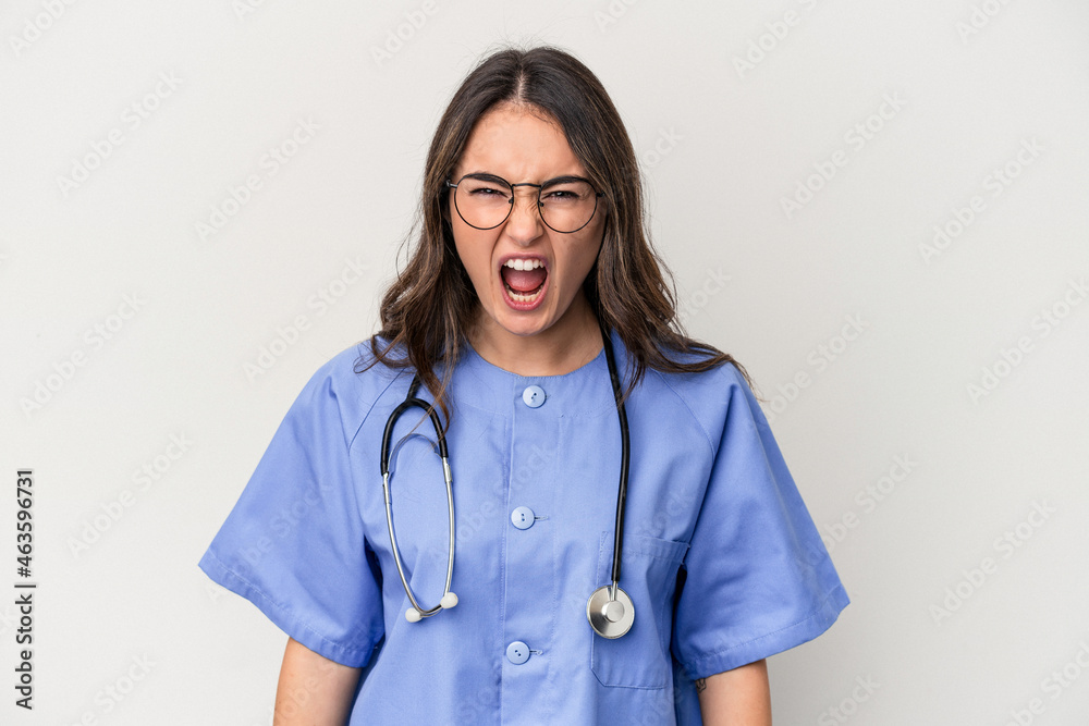 Young caucasian nurse woman isolated on white background screaming very ...