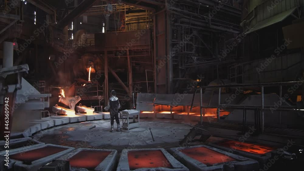 View inside a copper production plant, a worker in a copper bottling ...