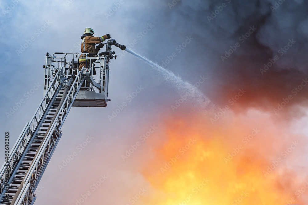 Fire truck telescopic tower. Fire inspector extinguishes fire. He pours ...