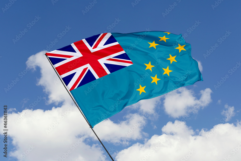 Tuvalu flag isolated on the blue sky background. close up waving flag ...
