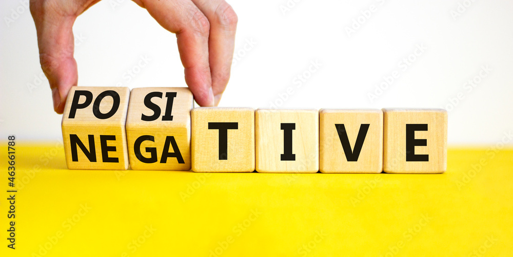 Positive or negative symbol. Businessman turns wooden cubes and changes ...
