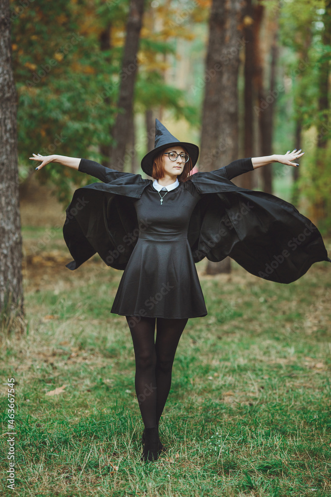 Halloween Witch. Portrait of a girl in a hat and a witch costume in the ...