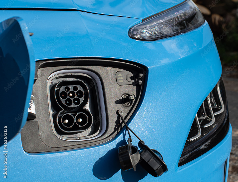Electric car e-car Type 2 charge socket on front of bright blue ...