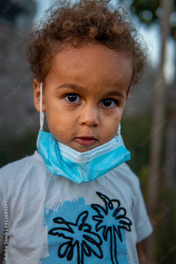 portrait of interracial ethiopian israeli toddler wearing a disposable ...