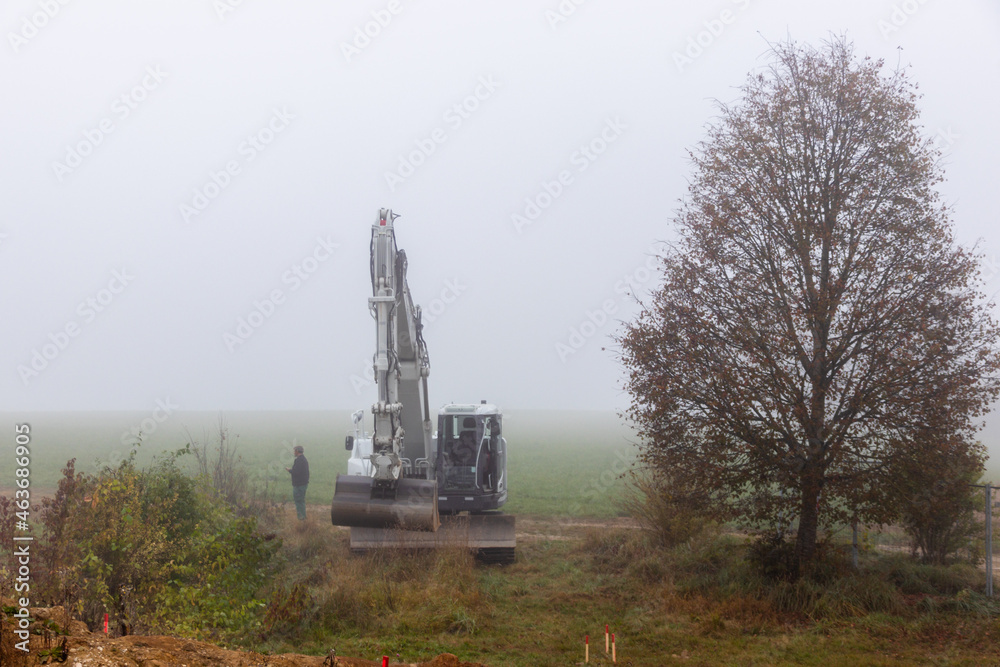 Ein Bagger und sein Baggerfahrer Stock Photo | Adobe Stock