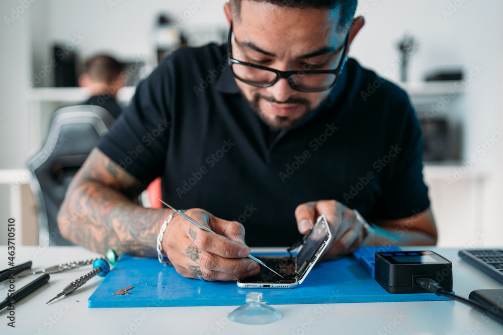 Engineer using tool to fix smartphone Stock Photo | Adobe Stock