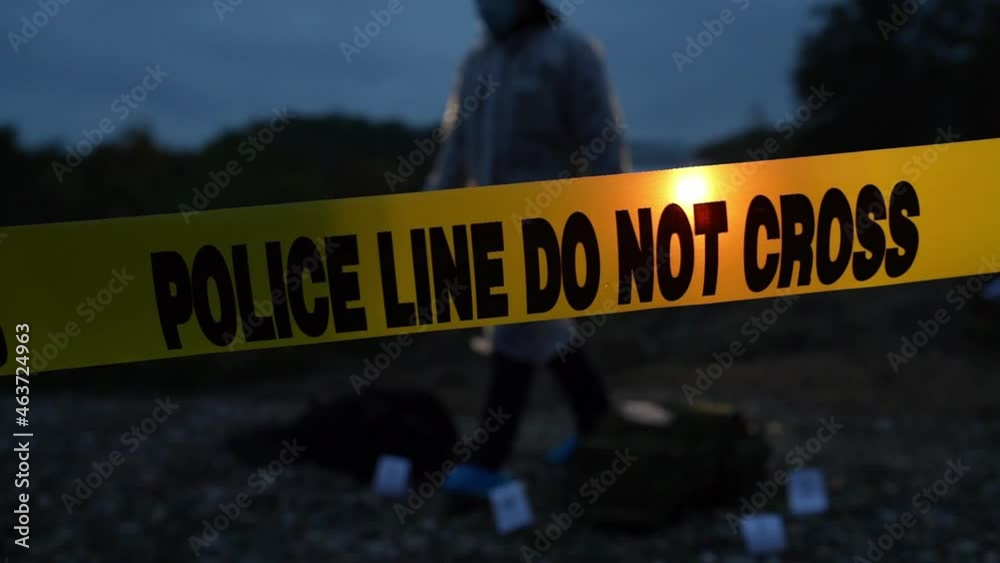 Forensic police investigator collecting evidence at the crime scene by ...