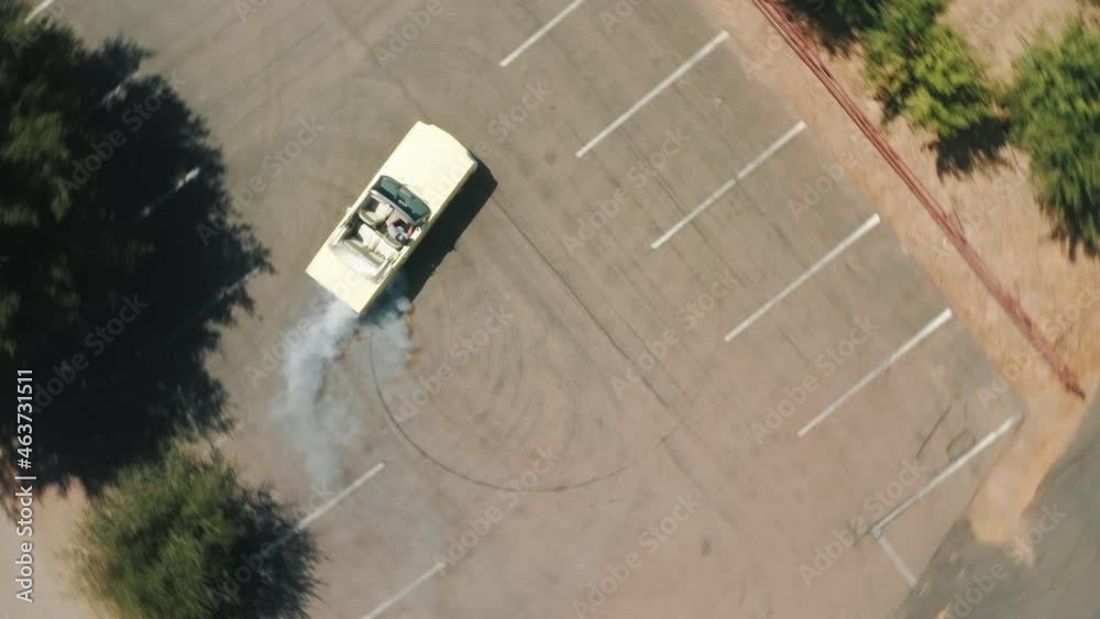 Aerial top down view on vintage automobile drifting on empty parking ...