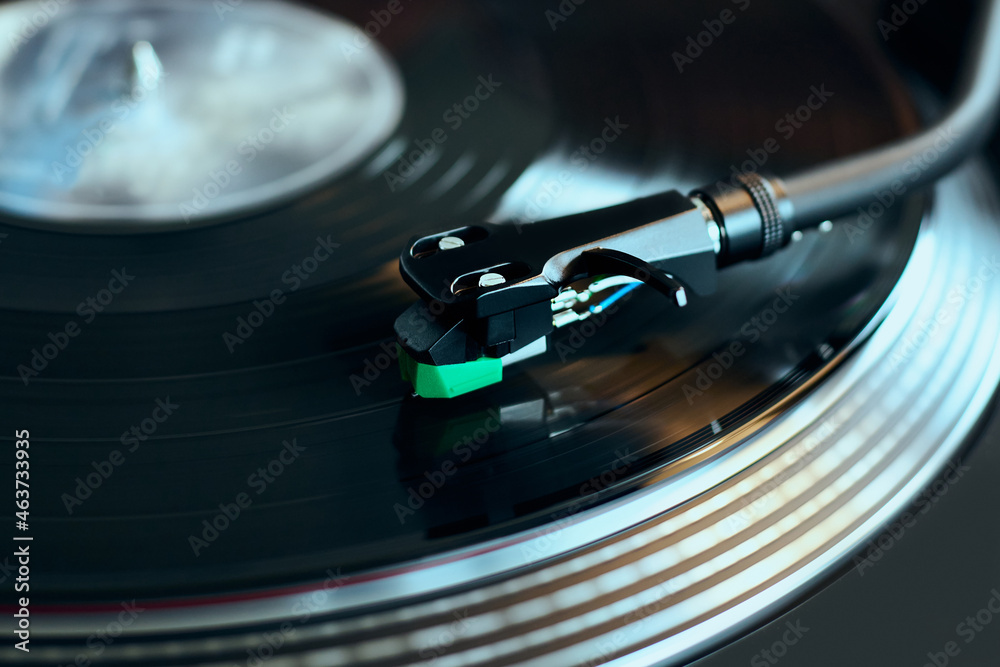 Vinyl record playing on turntable Stock Photo | Adobe Stock