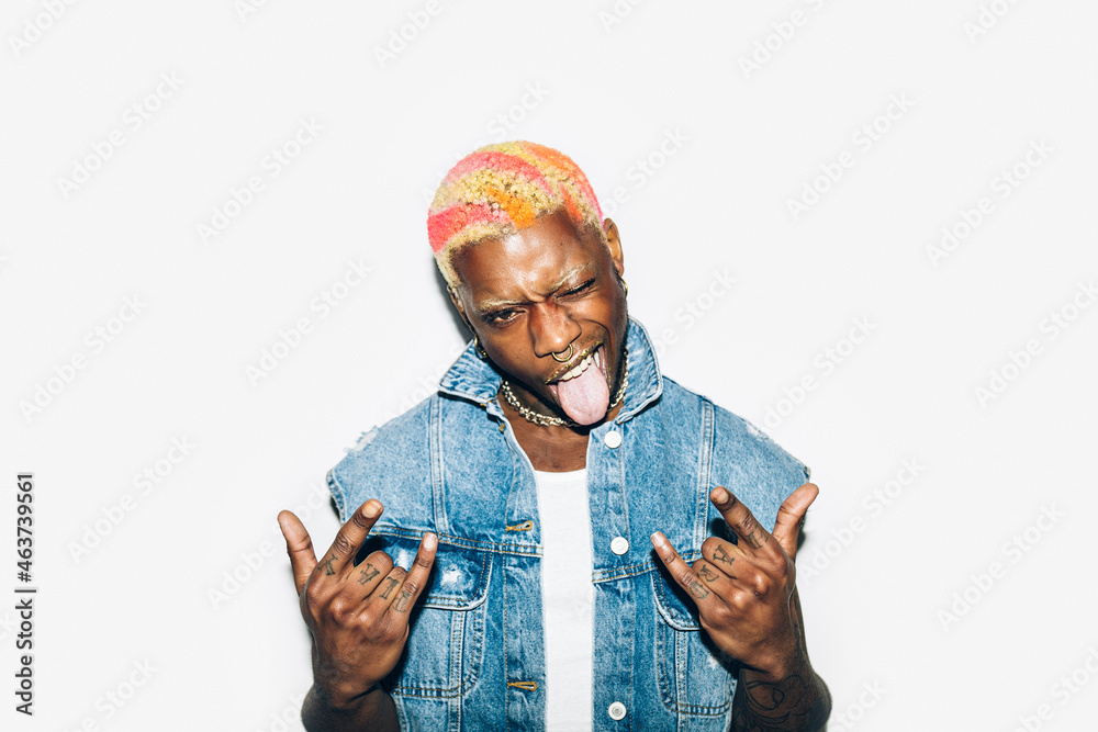 Punk man showing his tongue doing a rock n roll gesture Stock Photo ...