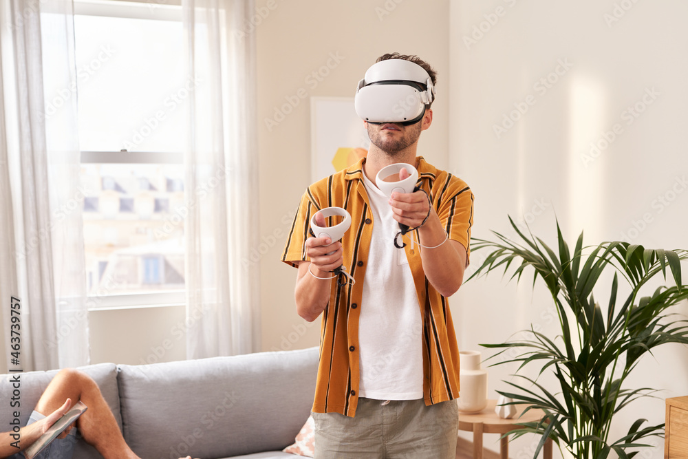 Concentrated man in VR glasses. Stock Photo | Adobe Stock