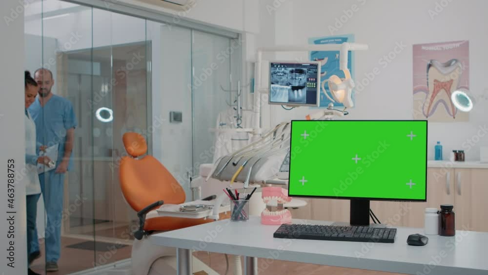 Horizontal green screen on computer in dentist office while specialists ...