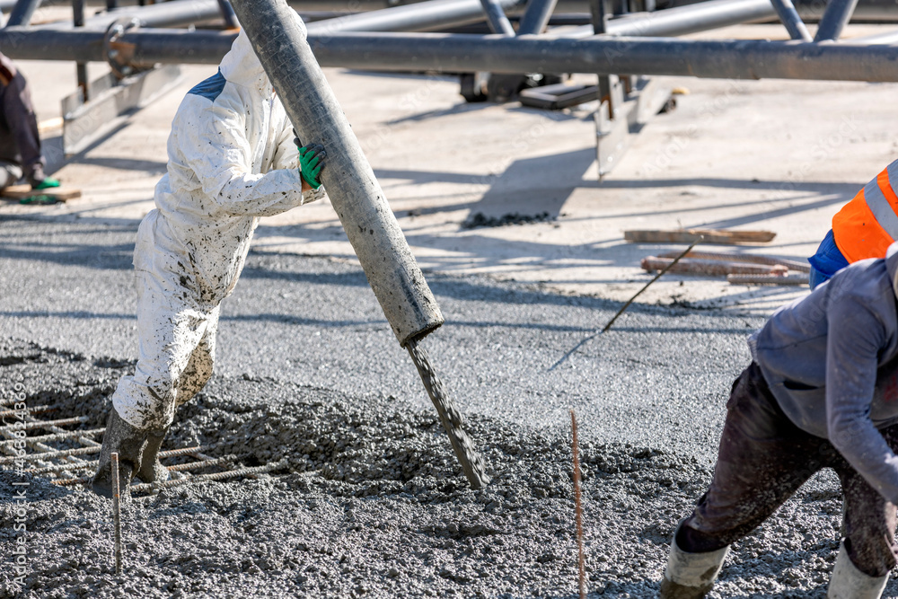 Pouring and smoothing out concrete with ready-mix concrete (RMC) in the ...