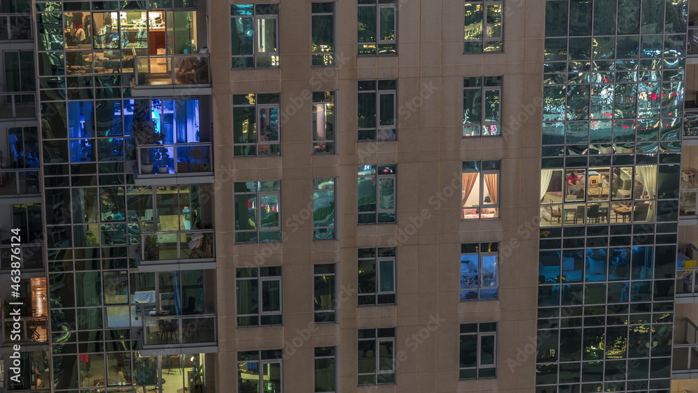 Windows in high-rise building exterior in the late evening with ...
