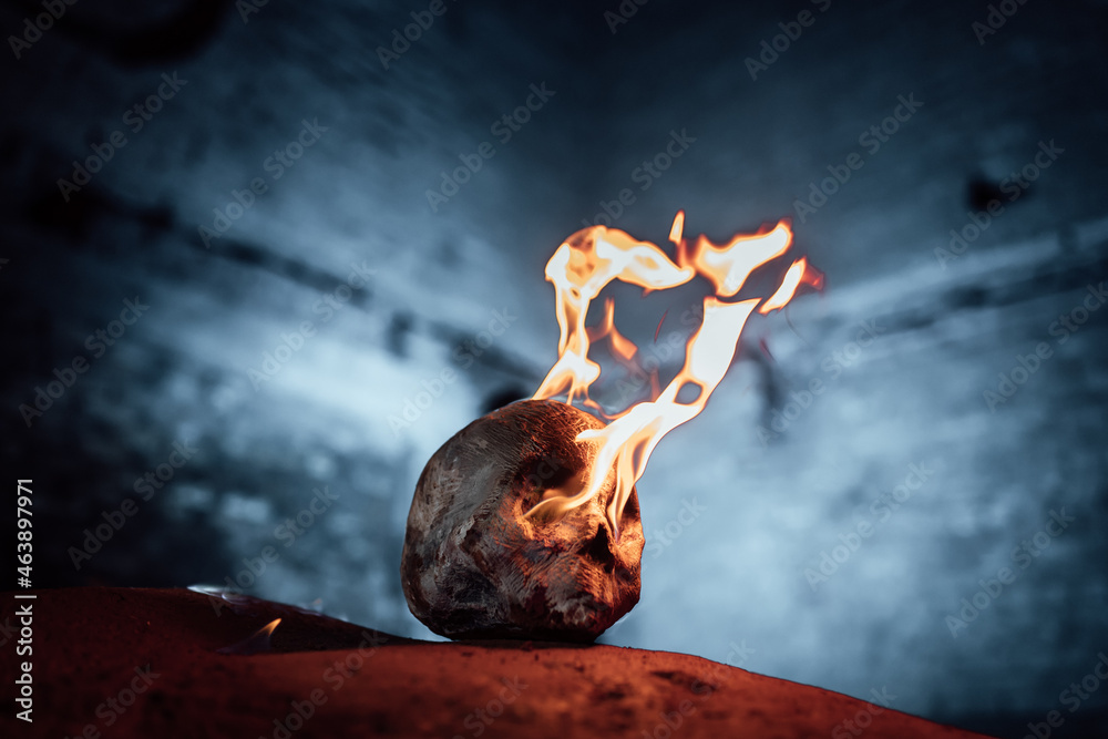 a burning human skull. flames from the eye sockets of the skull. a fake ...