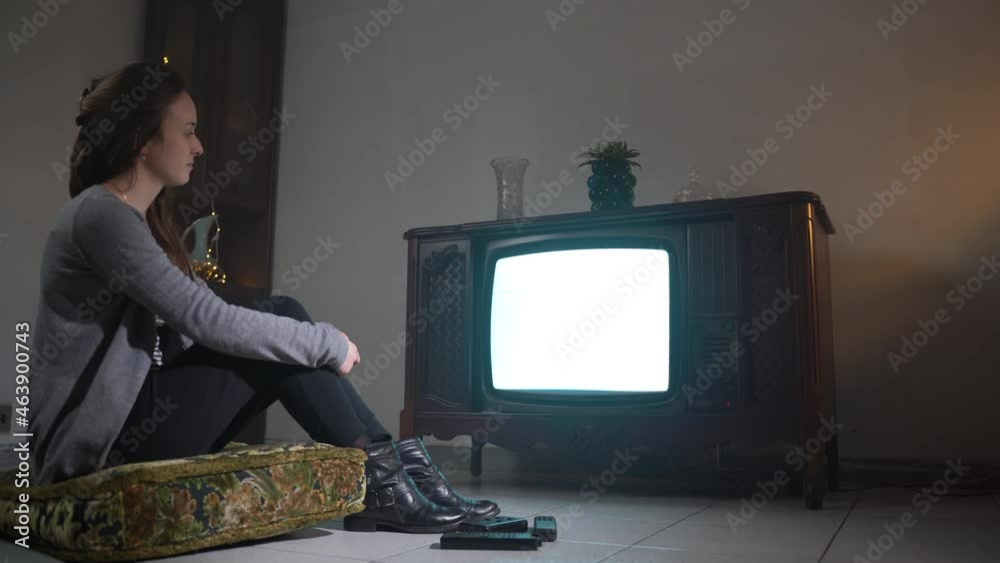 Lonely woman on isolation watching TV at home, sad female sitting on ...