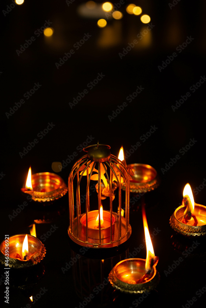 Multiple Brass Diya Illuminated with a decorative candle holder in ...