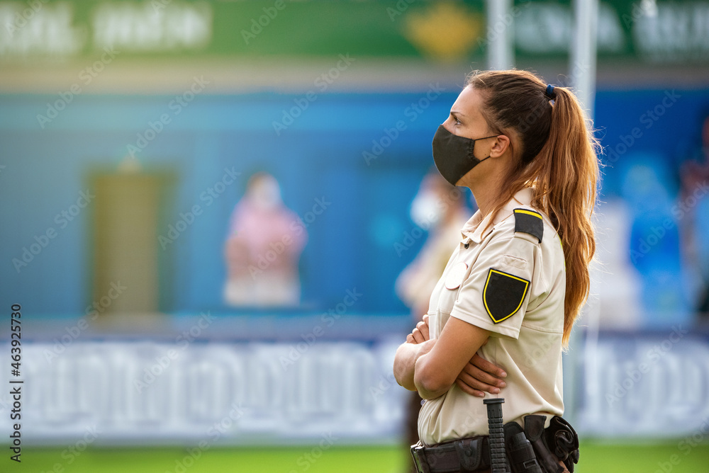 Female security guard visually surveying at an outdoor event Stock ...