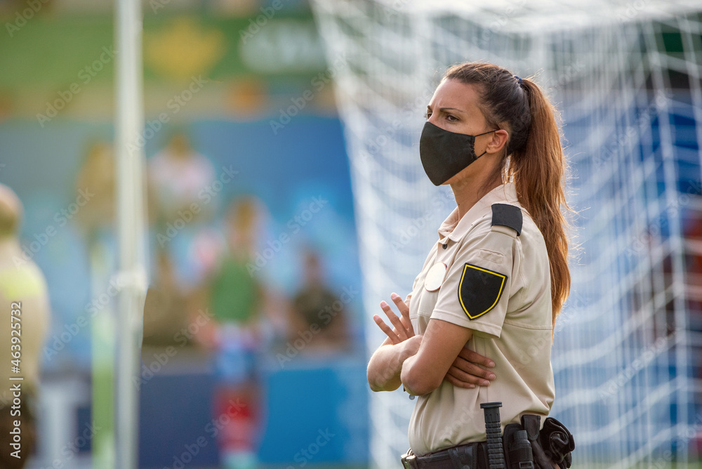 Female security guard visually surveying at an outdoor event Stock ...