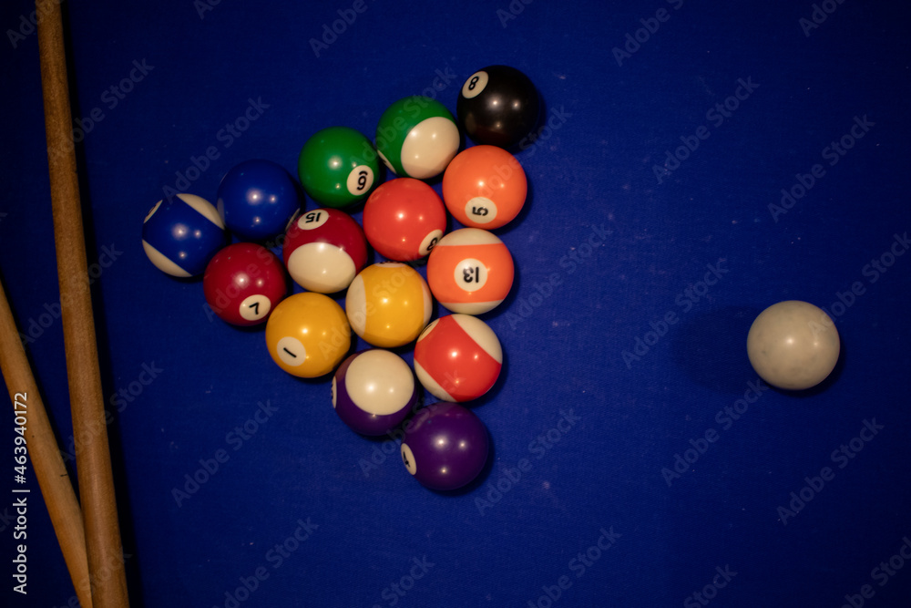 colored billiard balls arranged on the blue table with dashes on the ...