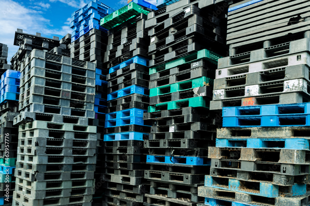 Pile of plastic shipping pallet. Industrial plastic pallet stacked at ...