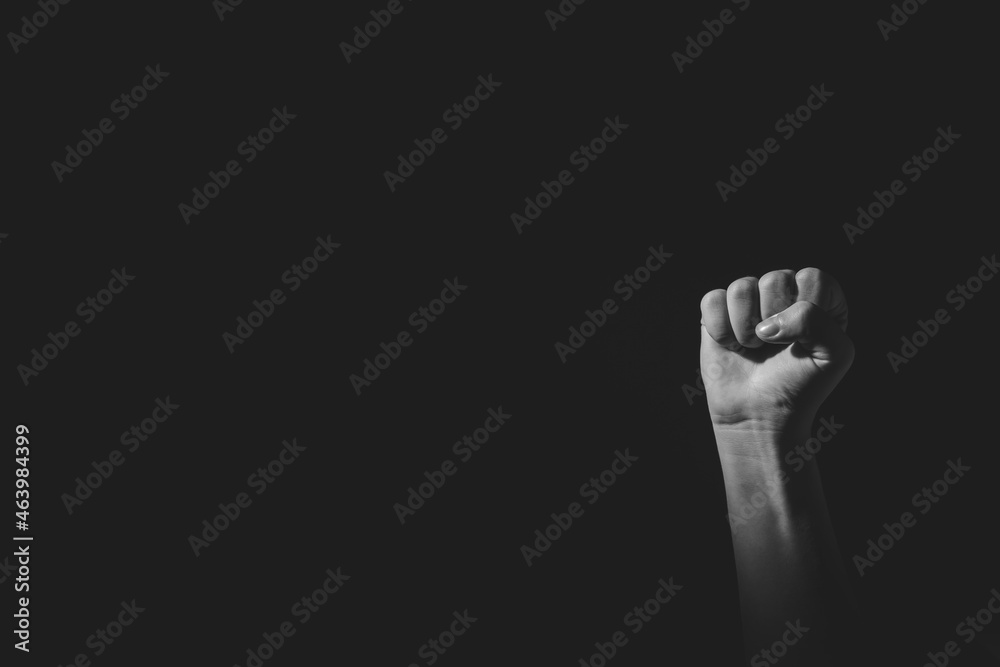 Fist pose hand with light and shadow, black an white, isolated on black ...