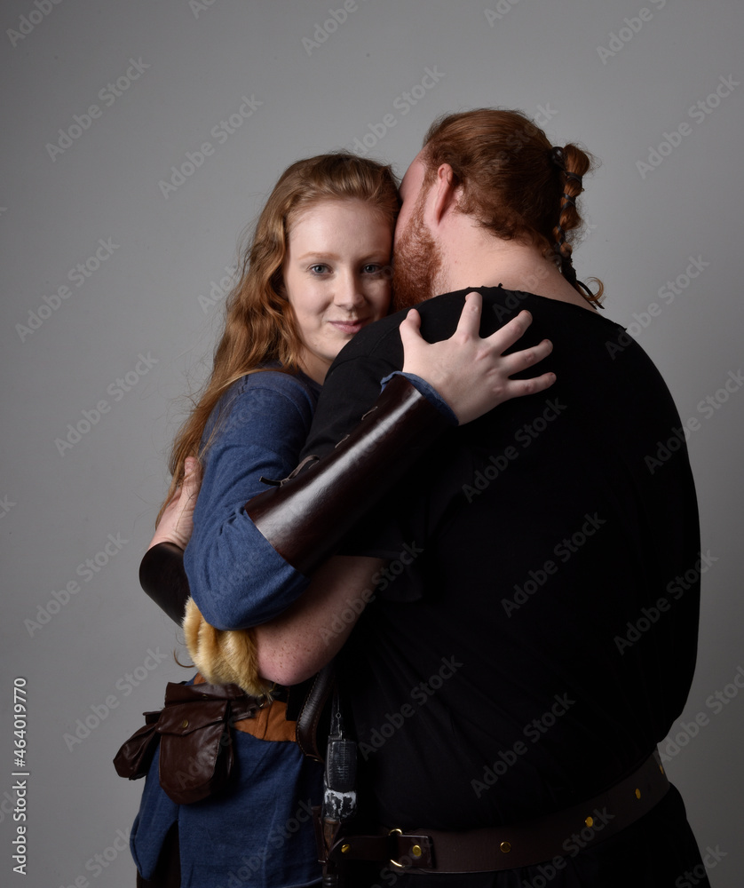 Full length portrait of red haired couple, man and woman wearing ...