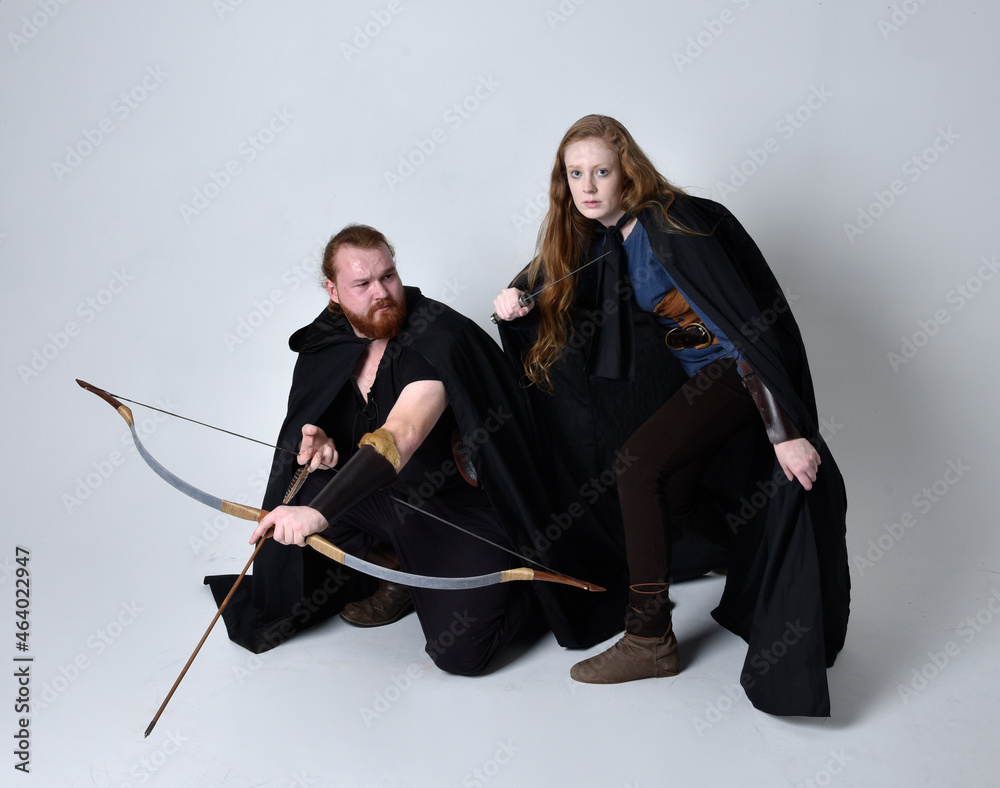 Full length portrait of red haired couple, man and woman wearing ...