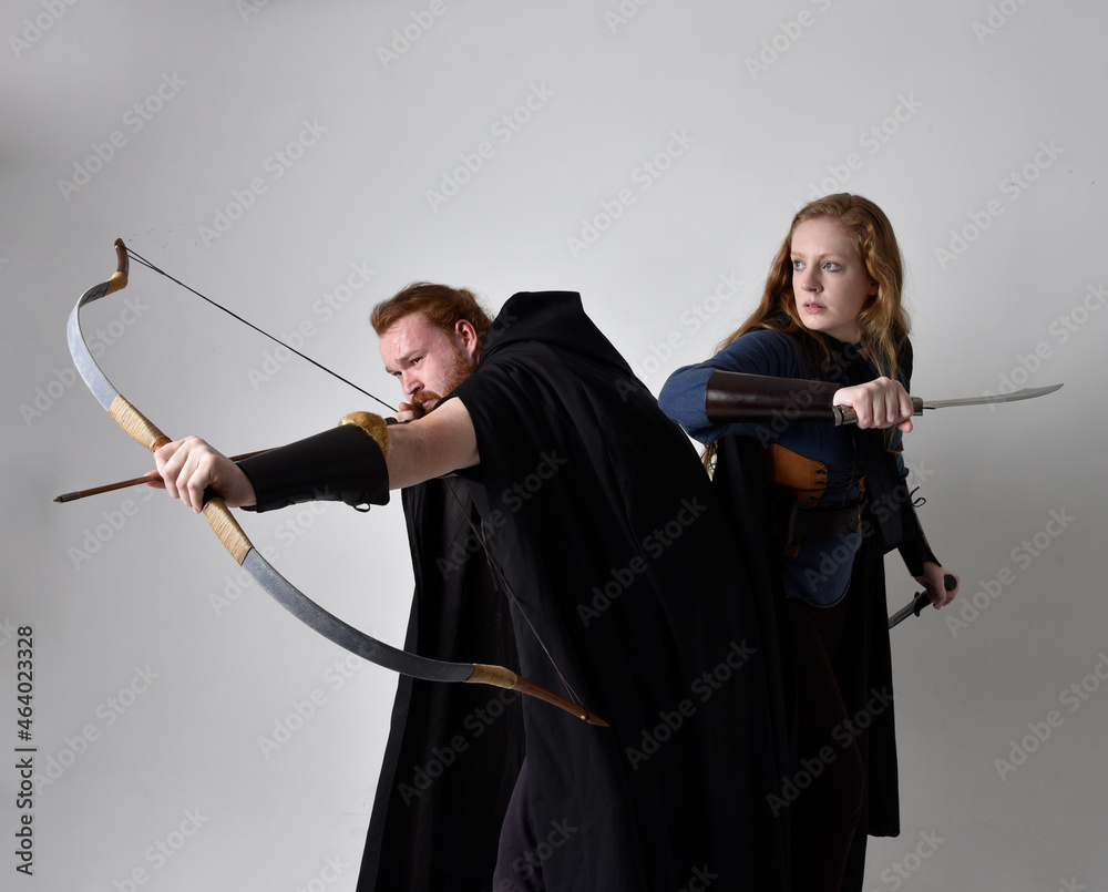 Full length portrait of red haired couple, man and woman wearing ...